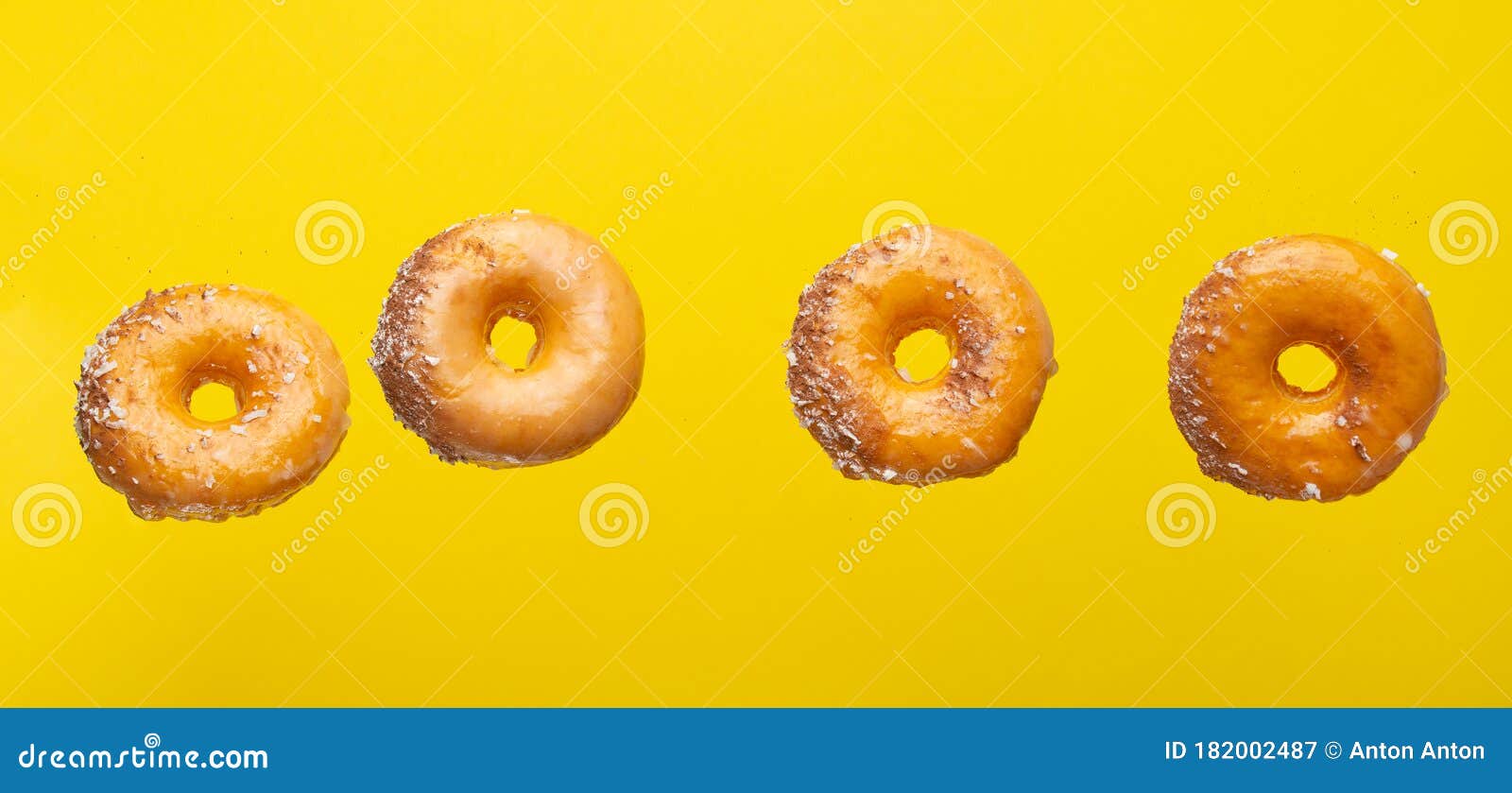 Various Decorated Donuts in Motion Falling on a Yellow Background Stock ...
