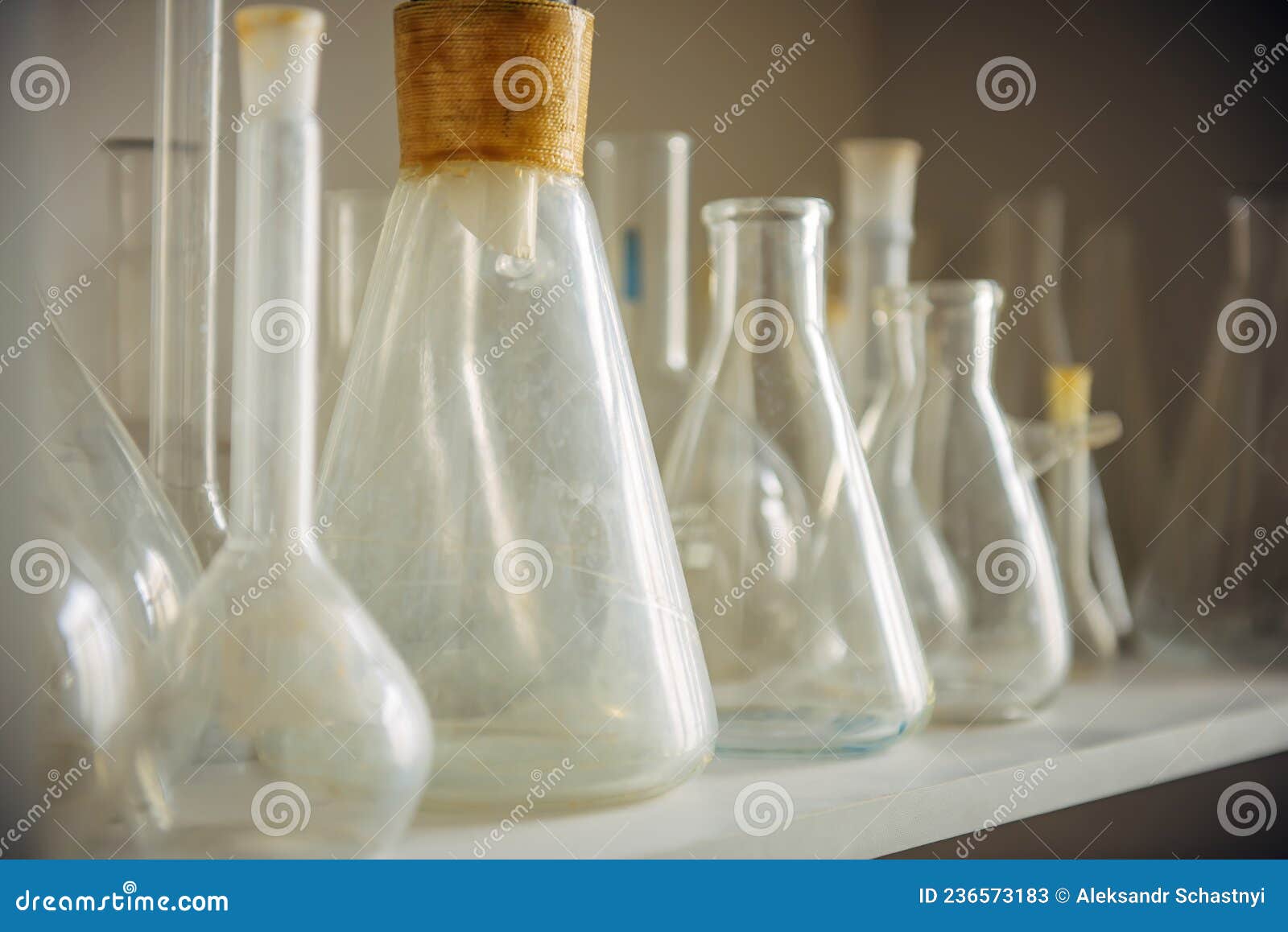 Various Glass Flasks on the Shelf, Close-up. Equipment for Experiments ...