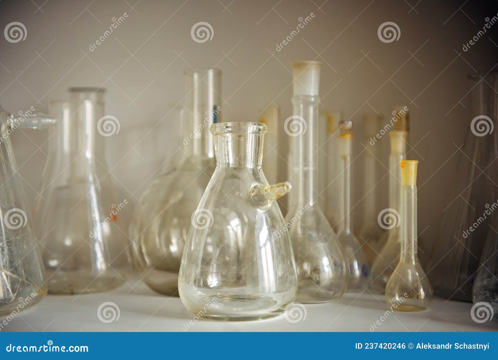 Various Glass Flasks on the Shelf, Close-up. Equipment for Experiments ...
