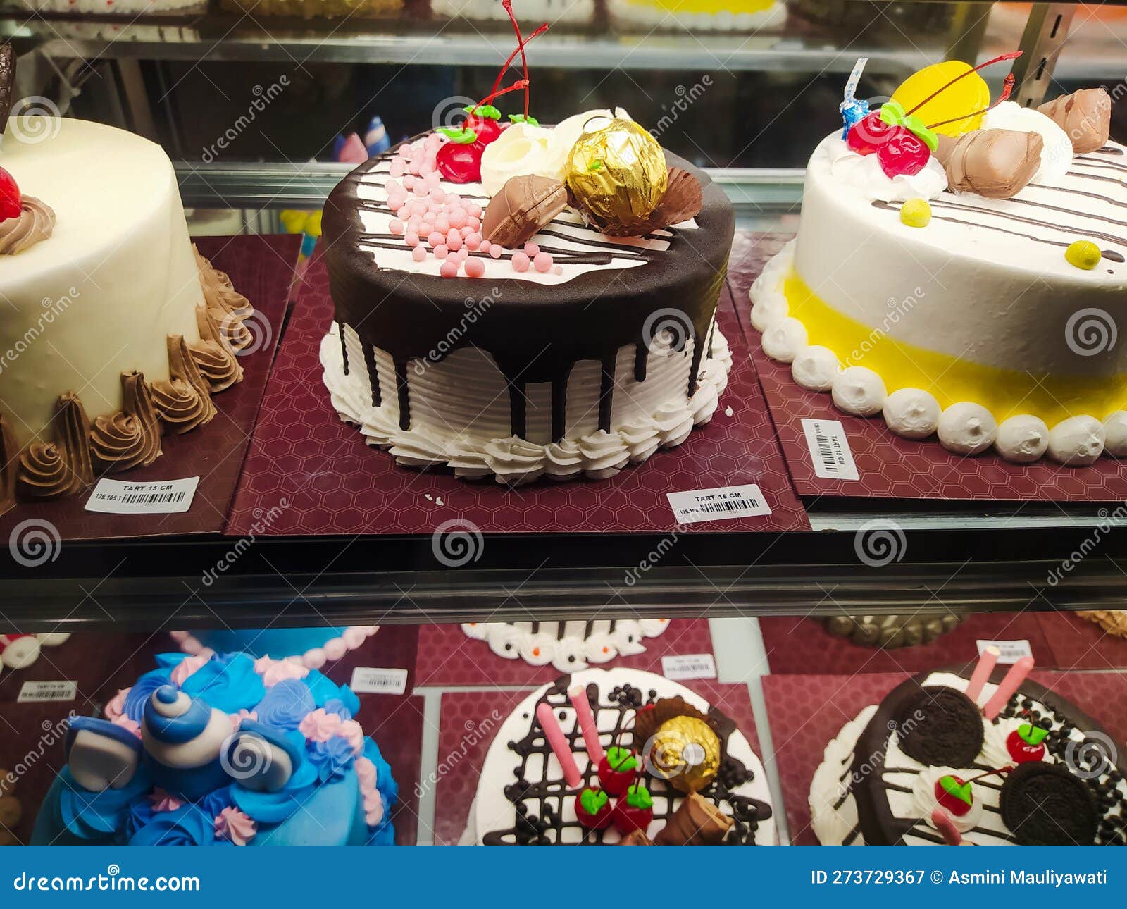 Various Kinds of Colorful Birthday Cakes on the Display Rack Stock ...