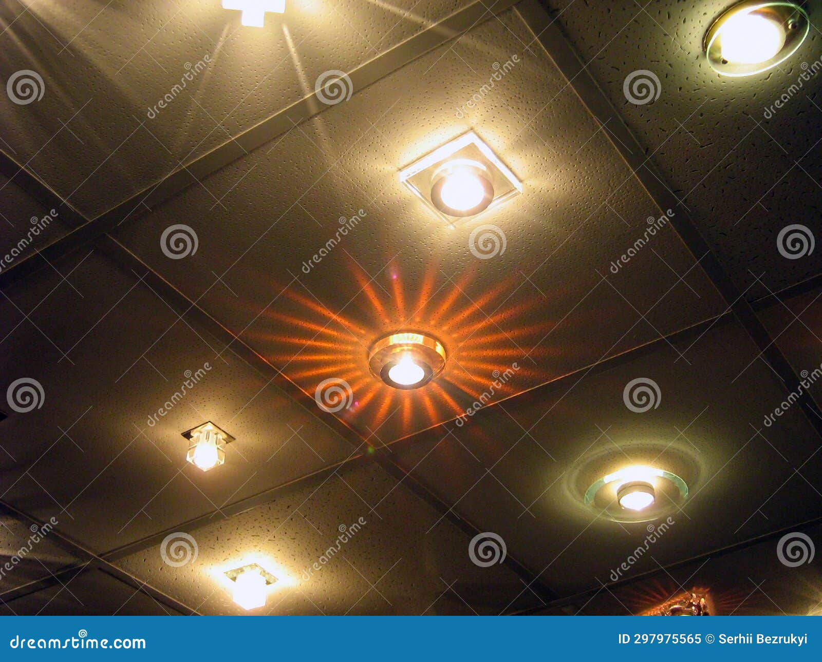 Various Lamps and Chandeliers Illuminate the Ceiling of the Apartment ...