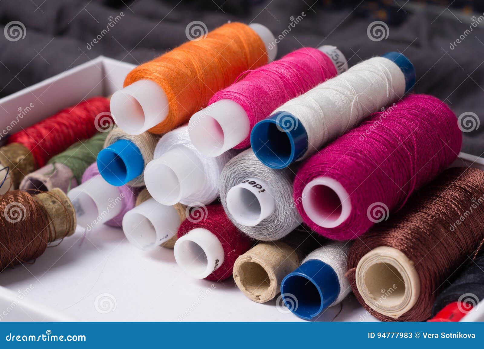 Various Multicolored Used Sewing Threads in a Box, Stacked in a Stock ...