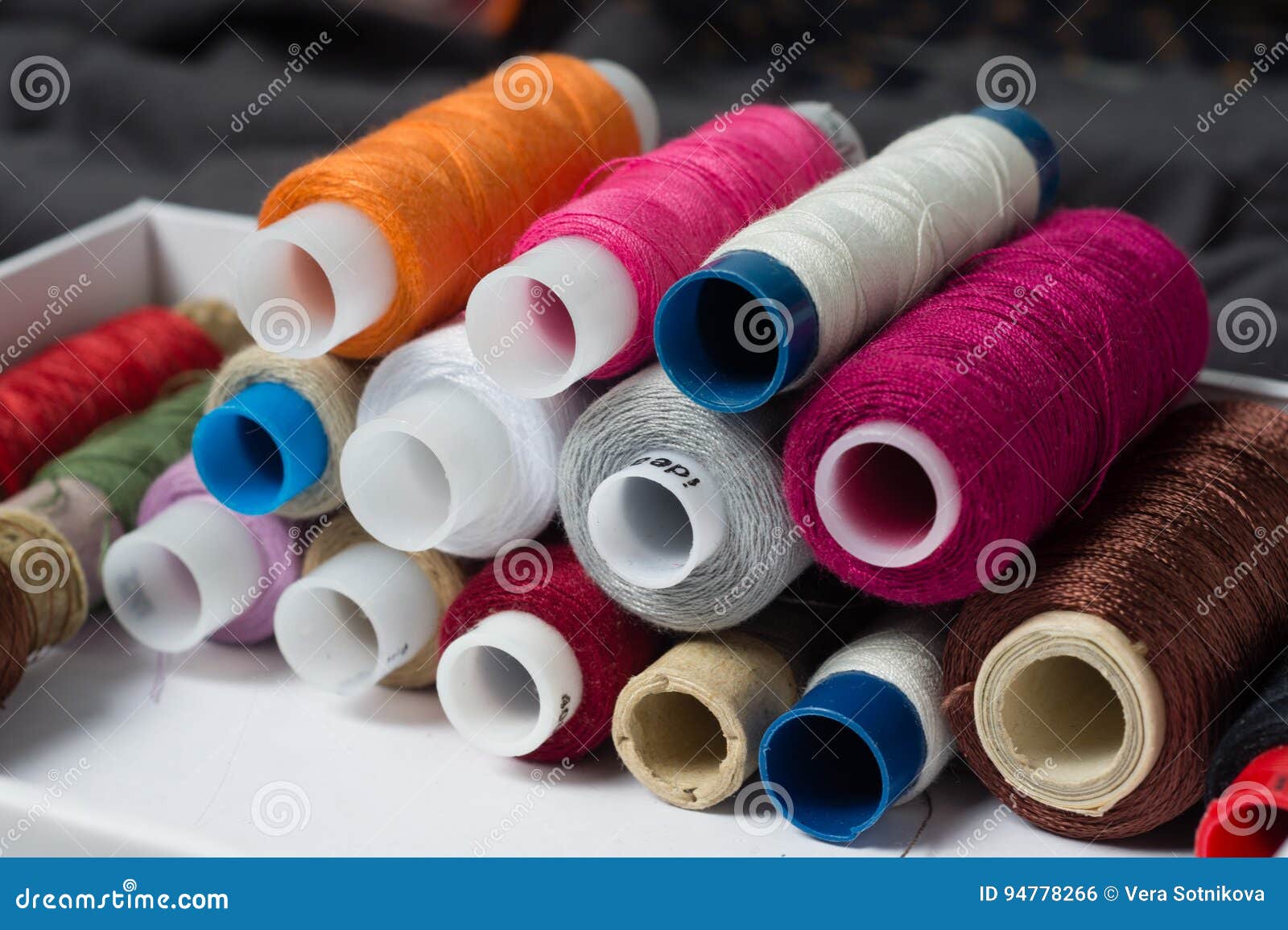 Various Multicolored Used Sewing Threads in a Box, Stacked in a Stock ...