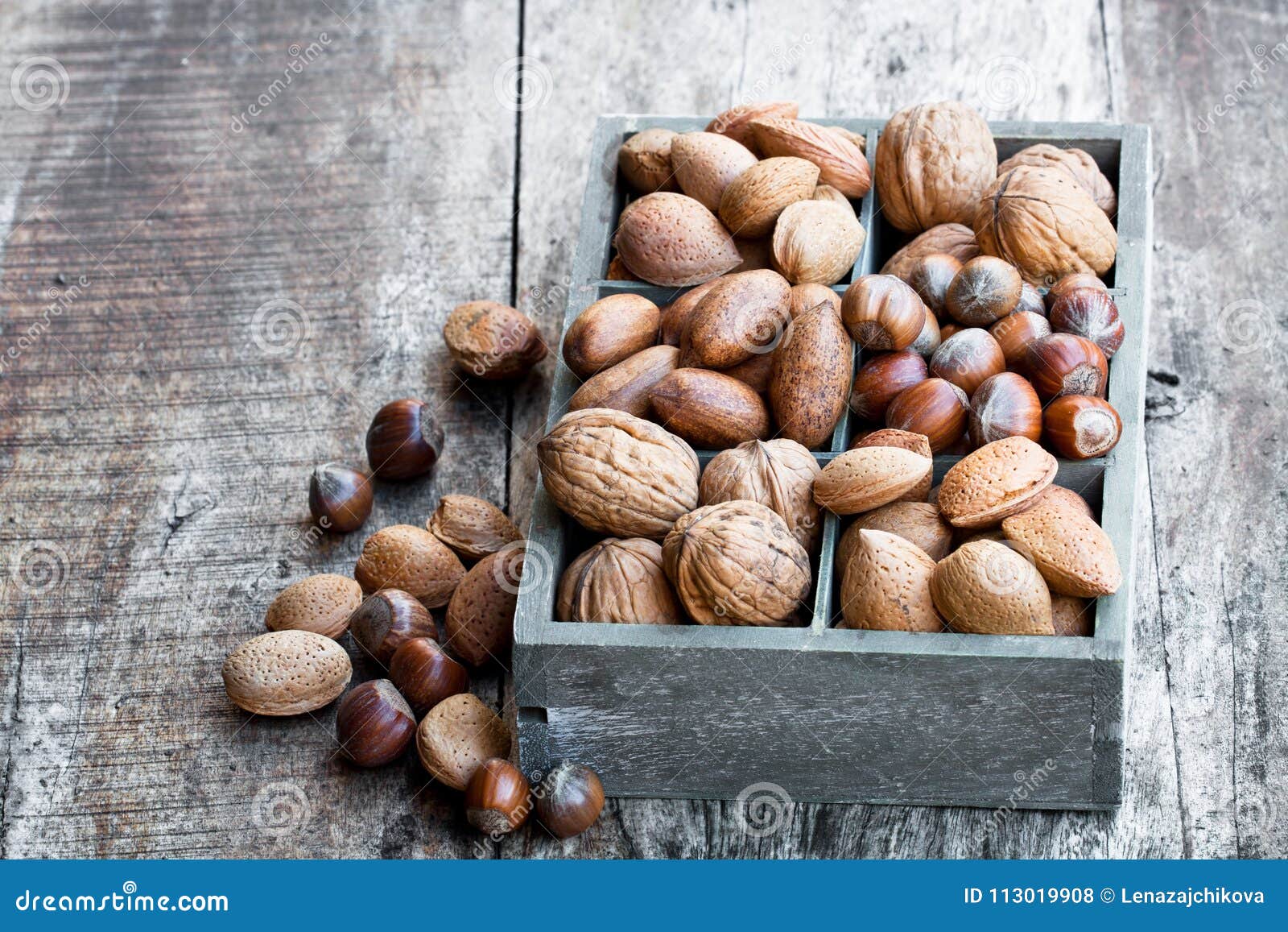 Various Nuts in Wooden Box on Rustic Table Stock Photo - Image of ...
