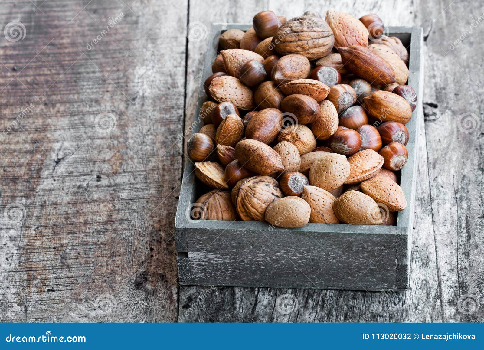 Various Nuts in Wooden Box on Rustic Table Stock Photo - Image of ...