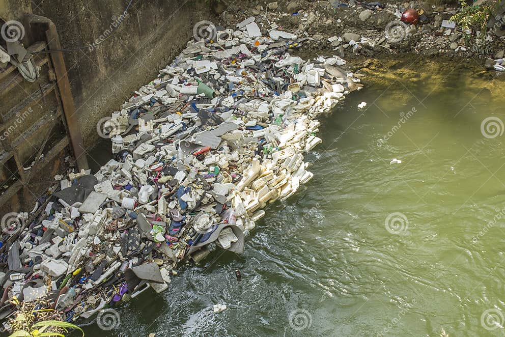 A Various Plastic and Rubber Garbage on the Dam in the River ...