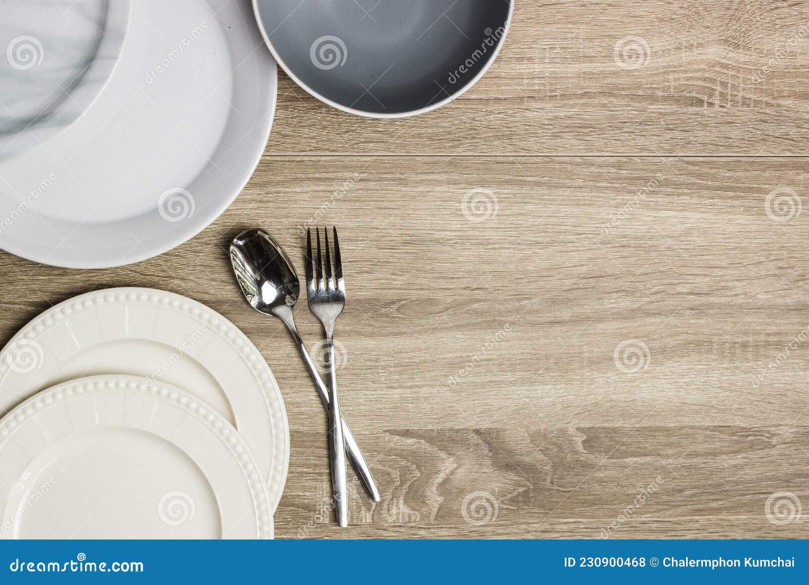 A Various of Plate with Spoon and Fork on a Wooden Table. Stock Photo ...