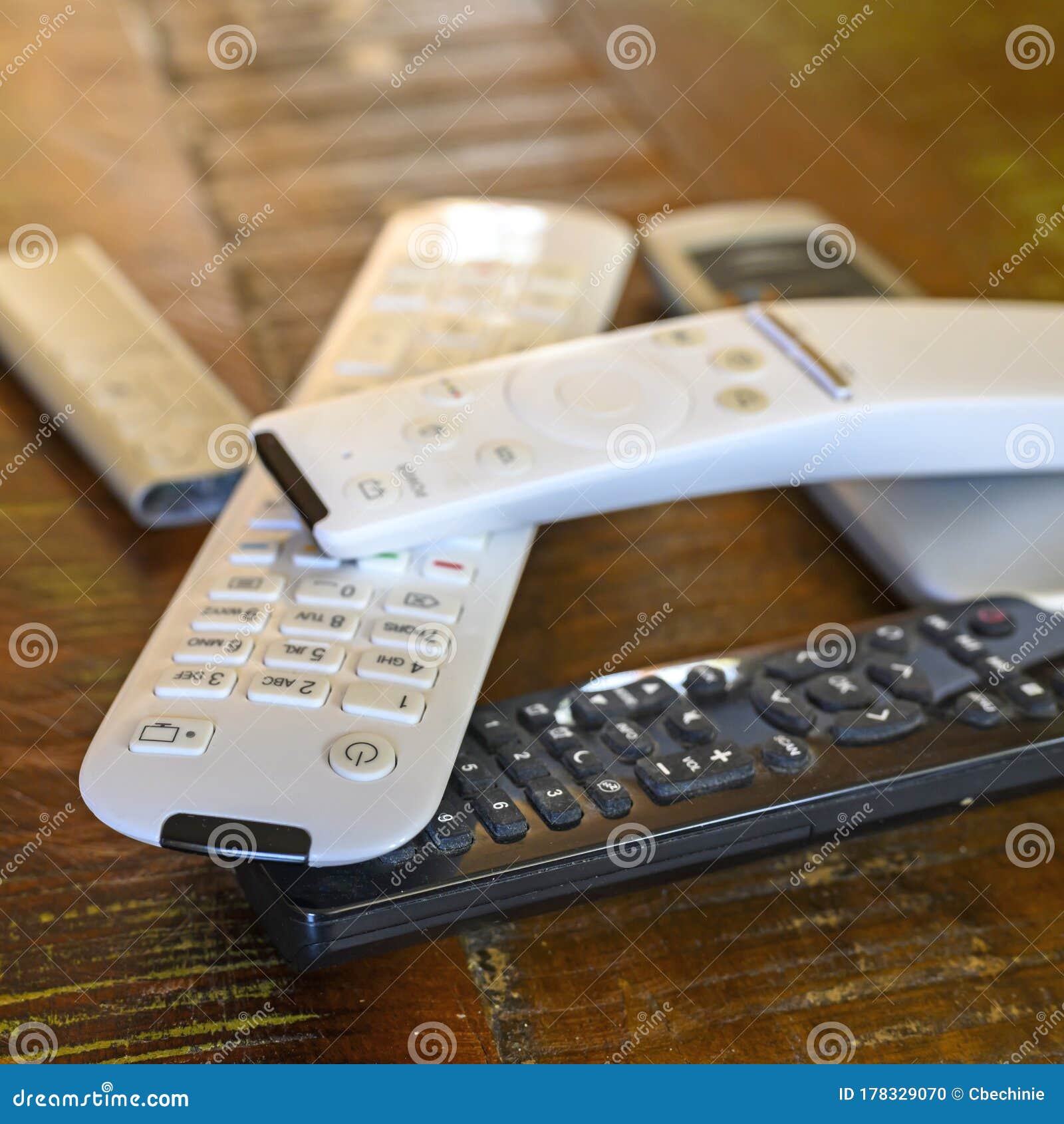 Various Remote Controls Lying on a Wooden Table Stock Photo - Image of ...