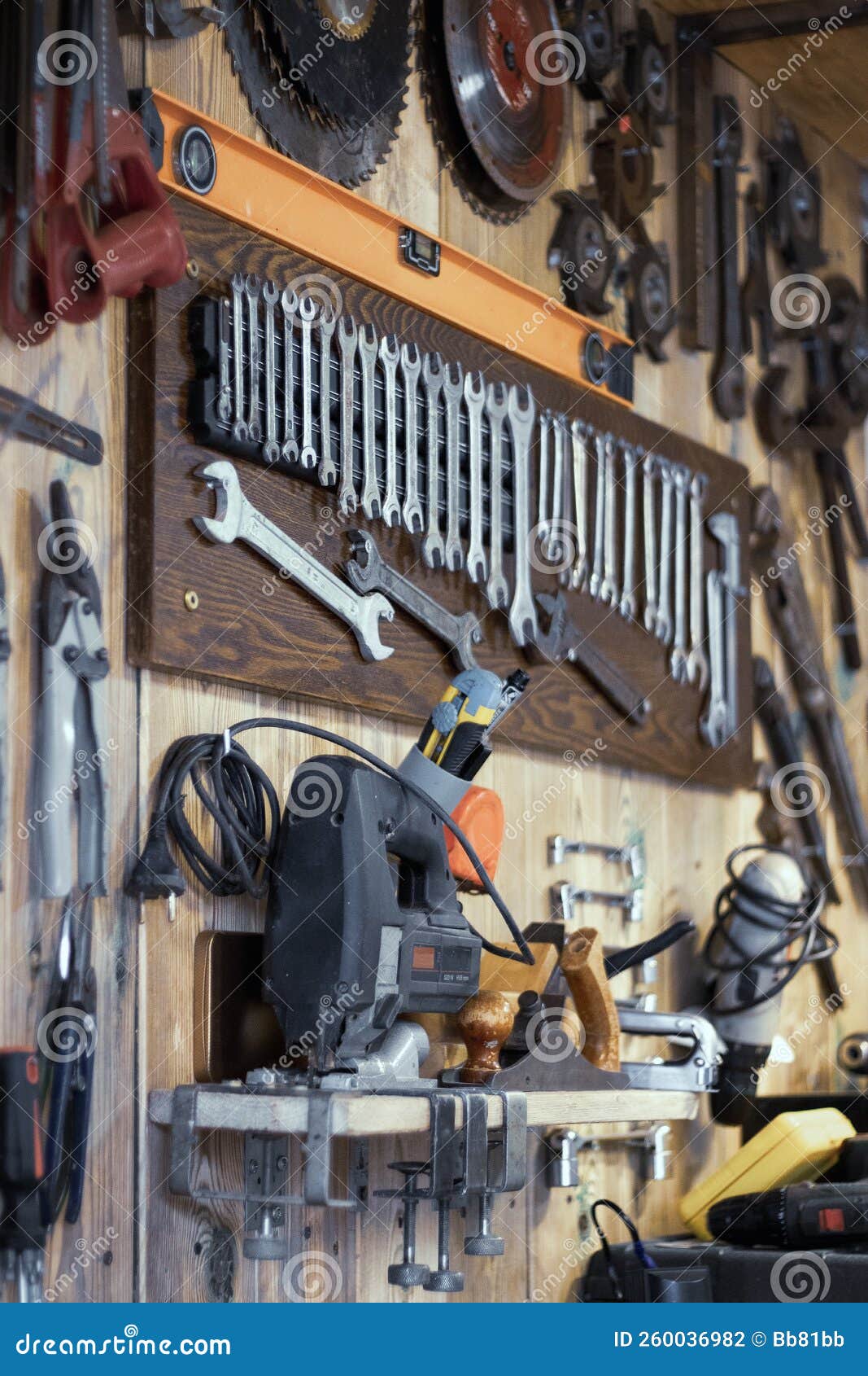 Various Tools Hang on a Wooden Wall in a Workshop Stock Photo - Image ...