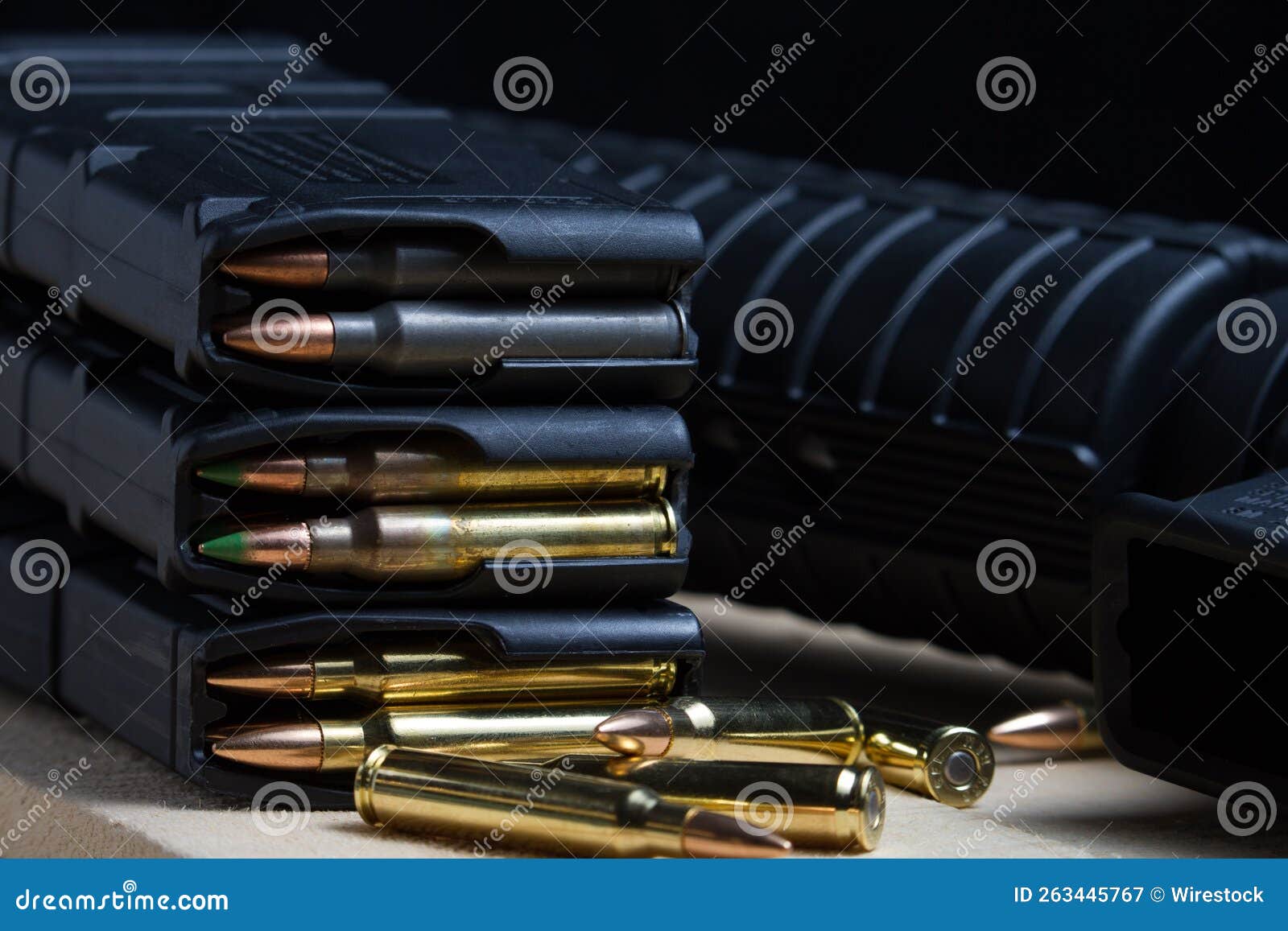 223 Rifle Ammunition Bullets in a Loaded Mag Arranged in Front of an AR ...