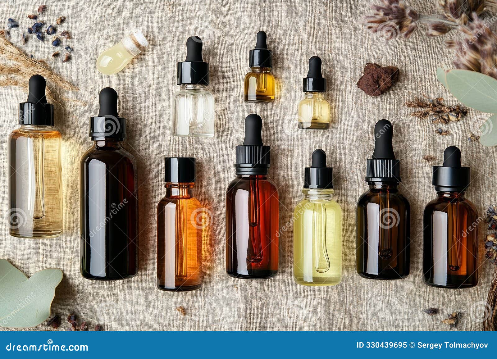 A Collection of Herbal Extract Bottles Displayed on a Natural Linen ...