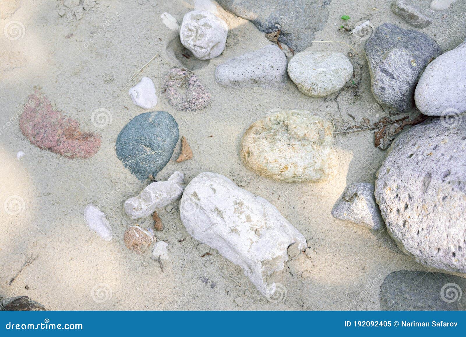 Various stones in the sand stock image. Image of round - 192092405