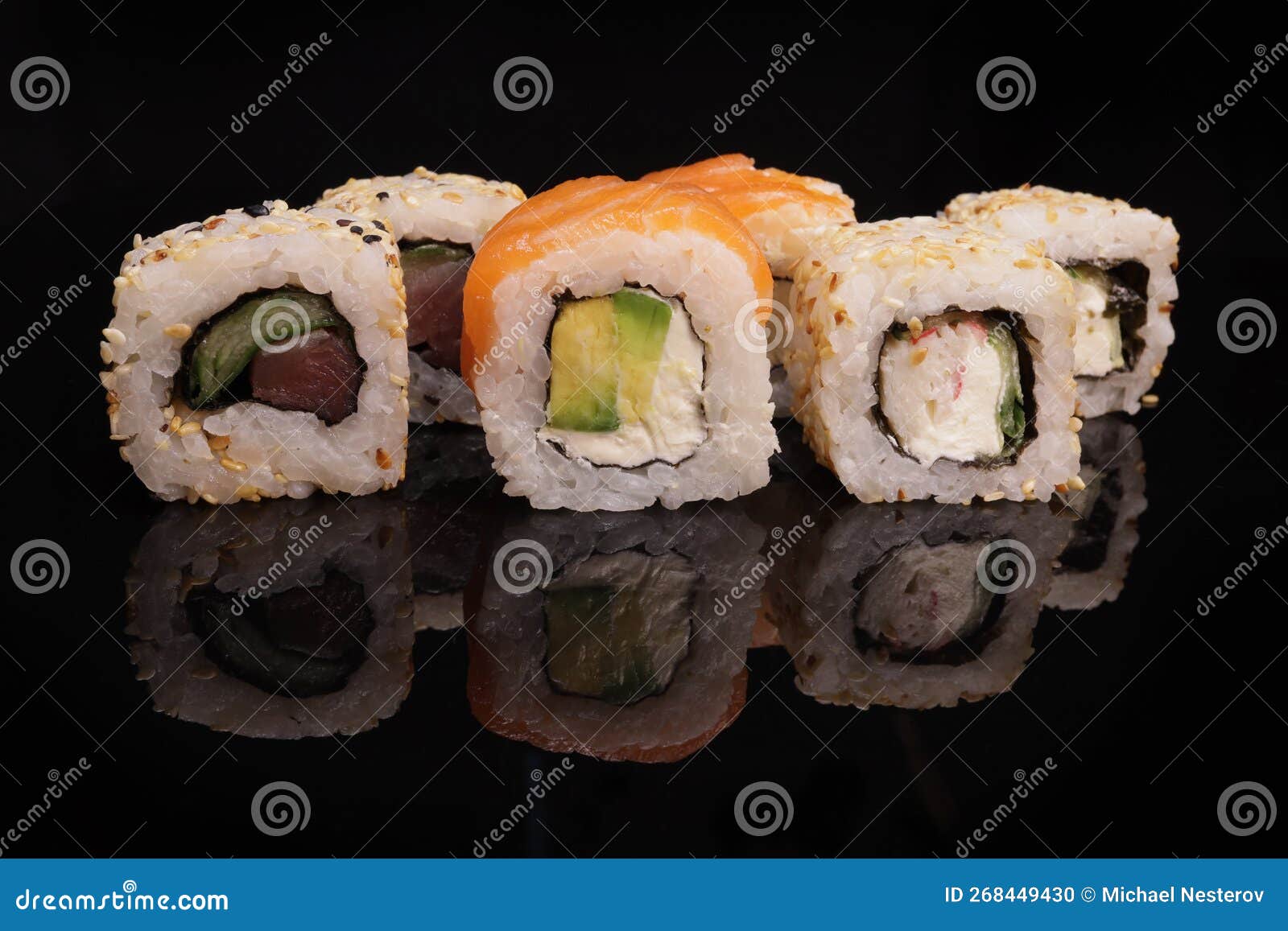 Various Sushi in a Row with Salmon, Tuna, Avocado, Sesame on a Mirror ...