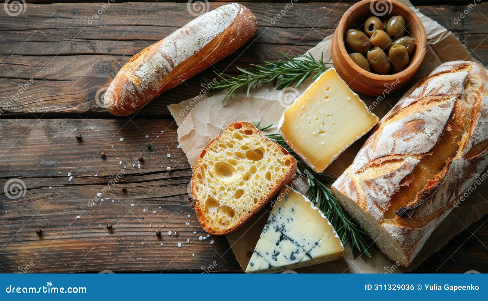 Assorted Breads and Cheeses on a Wooden Table Stock Photo - Image of ...