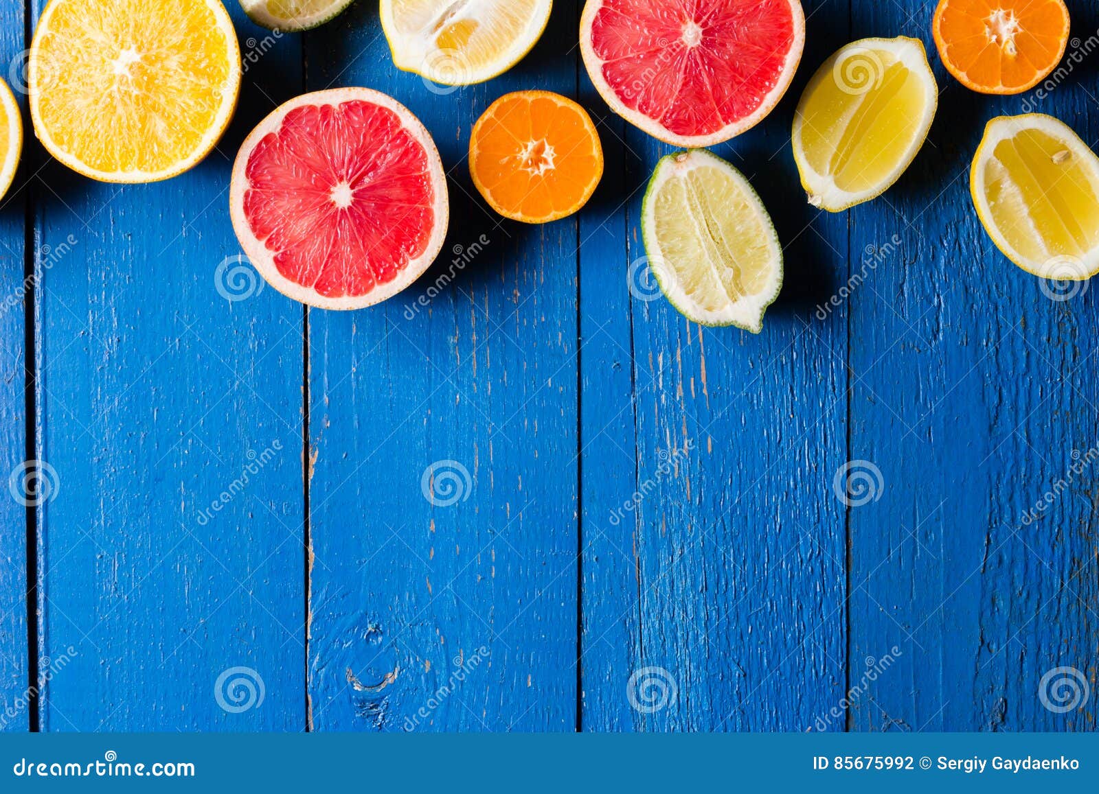 Various Types of Citrus Fruit on a Blue Painted Wooden Background Stock ...