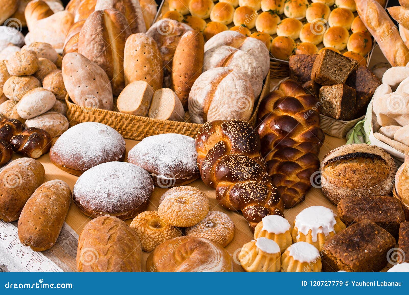 Various Types of Fresh Bread in a Table: Rum Baba, Challah, Wheat and ...