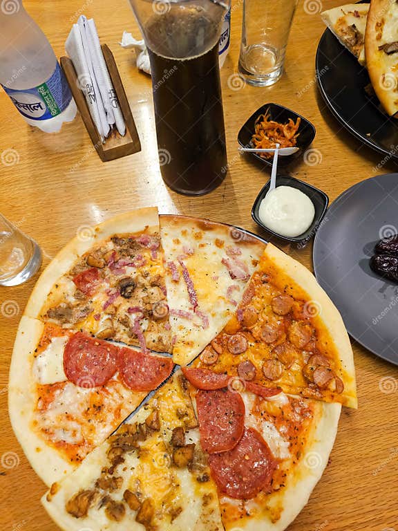 Various Types of Pizza with Different Types of Toppings Served on a ...