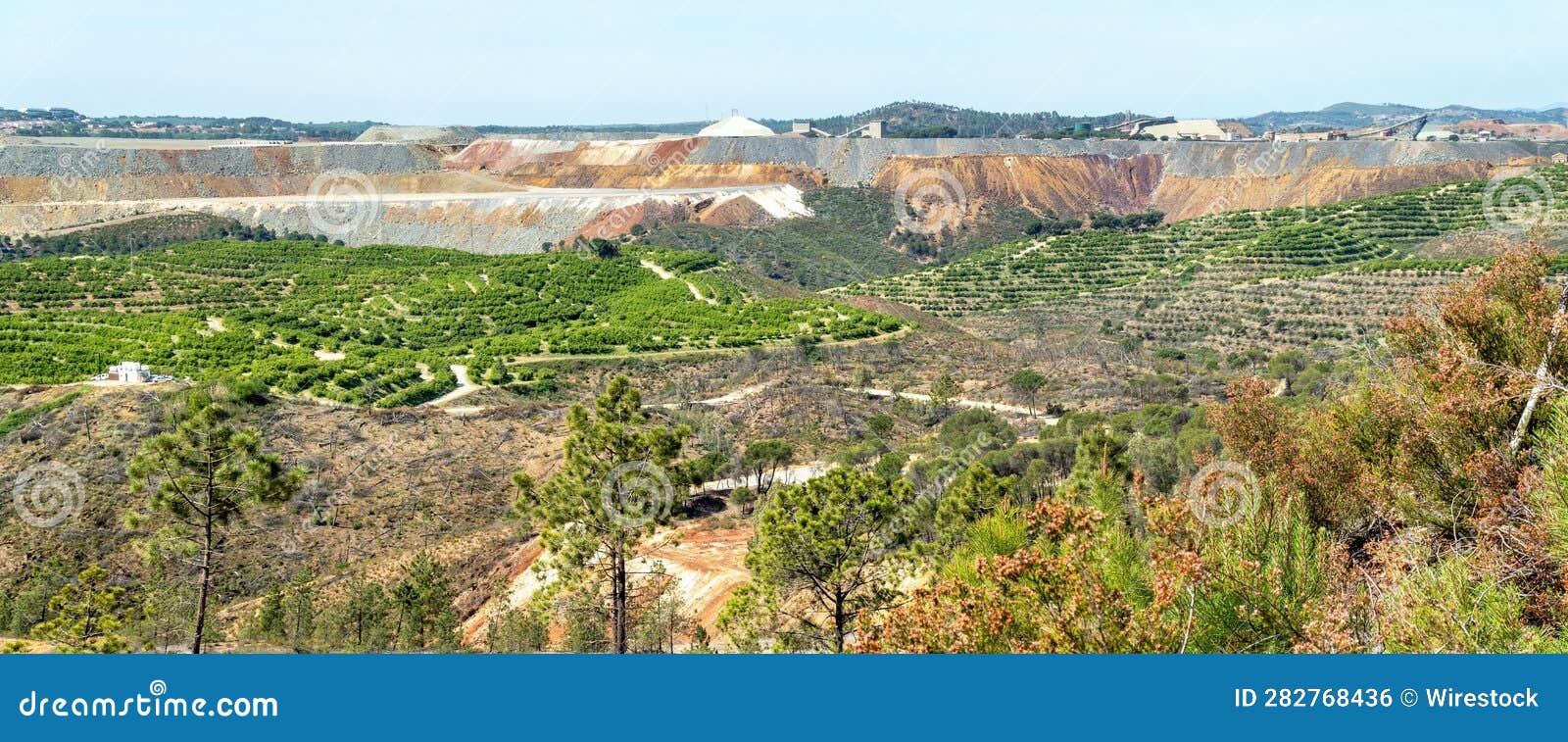 Vast Expanse of an Open-pit Mine Situated on a Hillside Covered in a ...