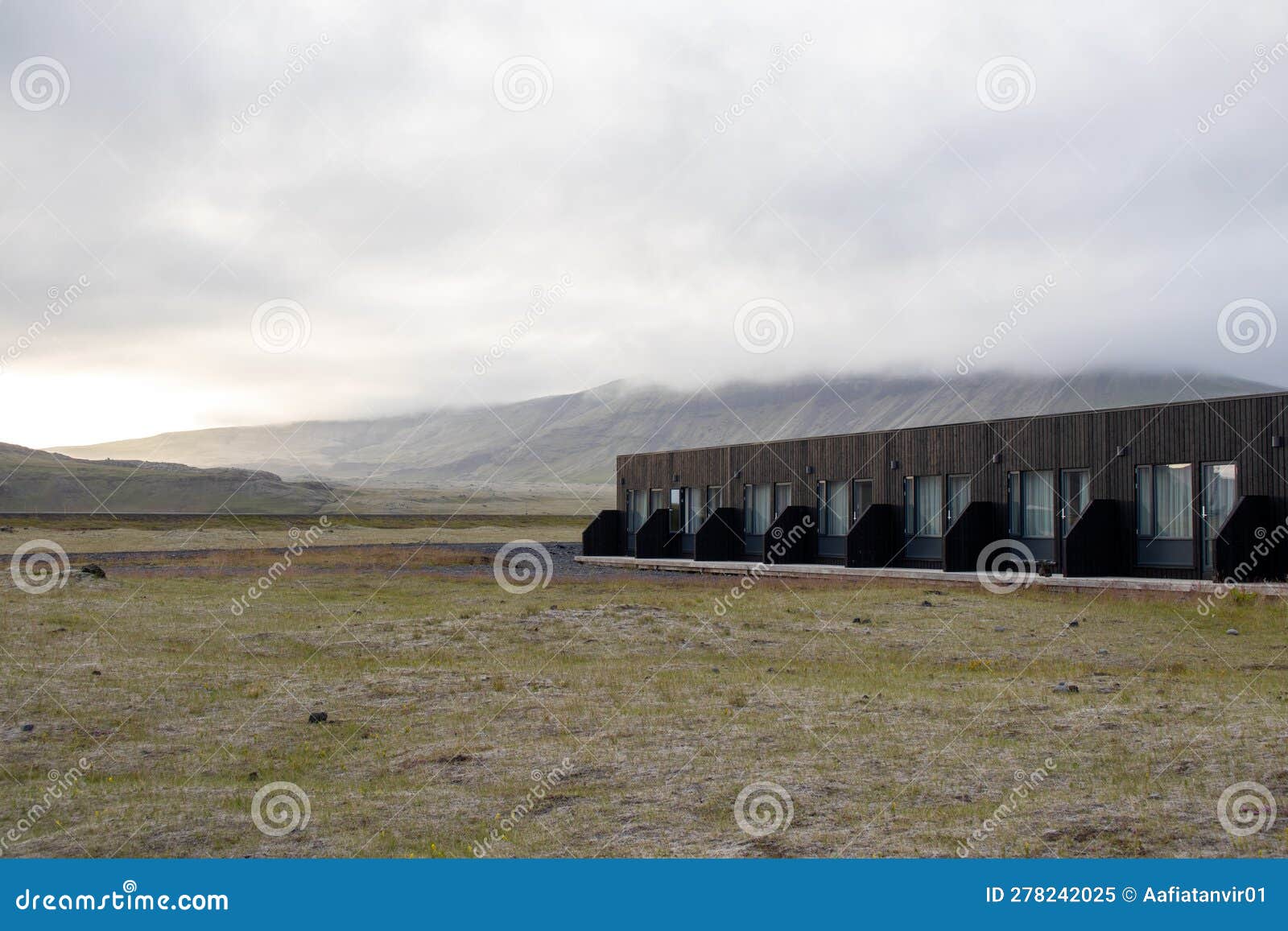 Vast Green Fields in Iceland with Mountains and Lodges Stock Image ...