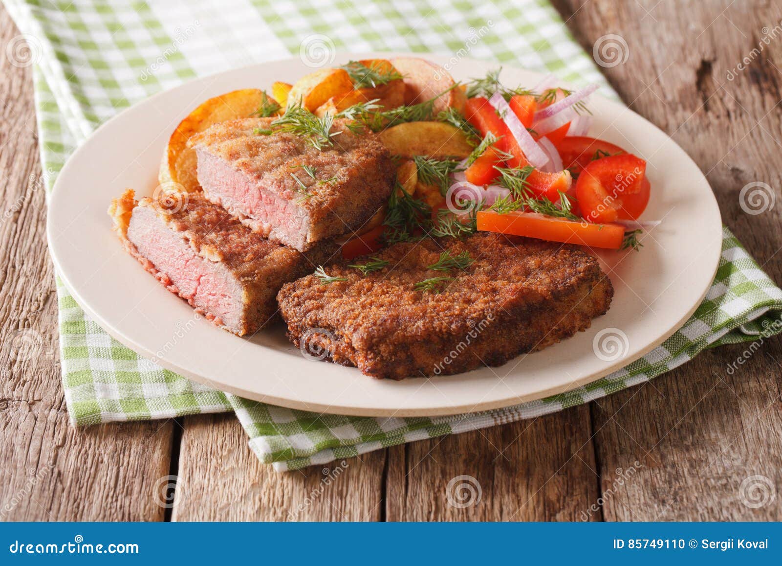 Veal Breaded Rump Steak and Garnished with Vegetables Close-up. Stock ...