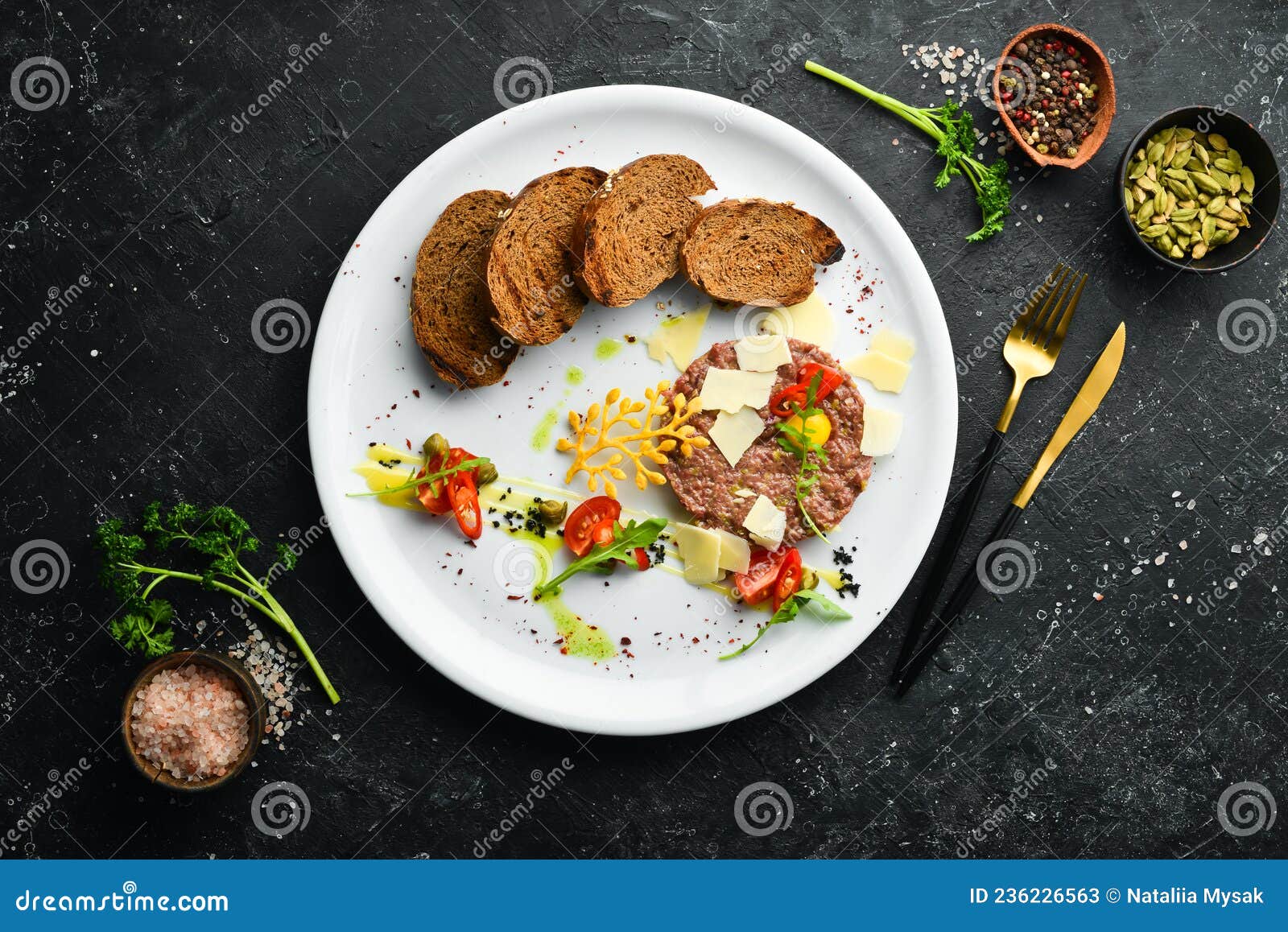 Veal Tar-tar, with Toast Bread and Vegetables on a White Plate. Stock ...