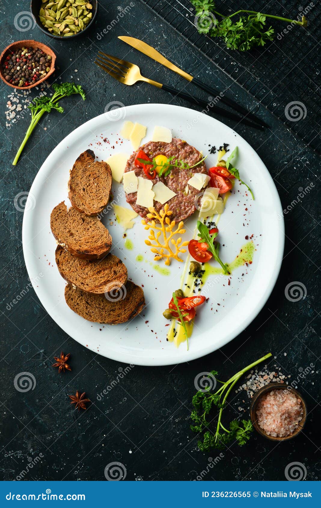 Veal Tar-tar, with Toast Bread and Vegetables on a White Plate. Stock ...