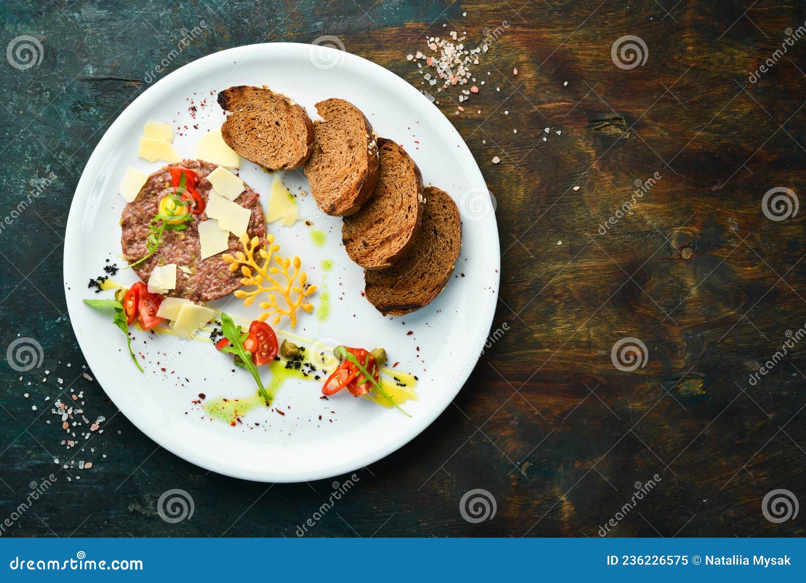 Veal Tar-tar, with Toast Bread and Vegetables on a White Plate. Stock ...