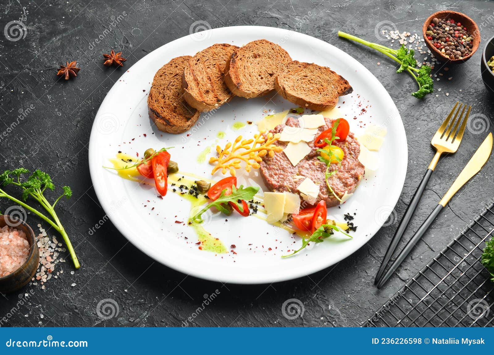 Veal Tar-tar, with Toast Bread and Vegetables on a White Plate. Stock ...
