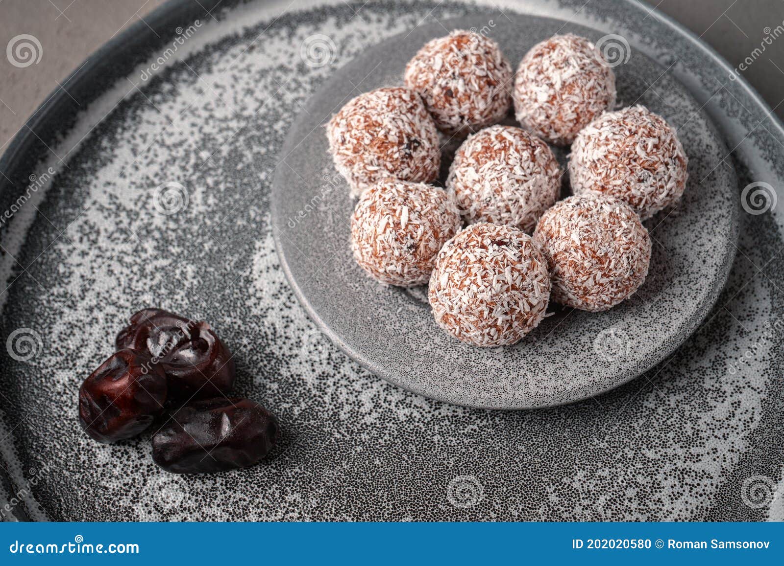 Vegan Date Candy on a Gray Plate Next To the Dates on a Concrete Tray ...