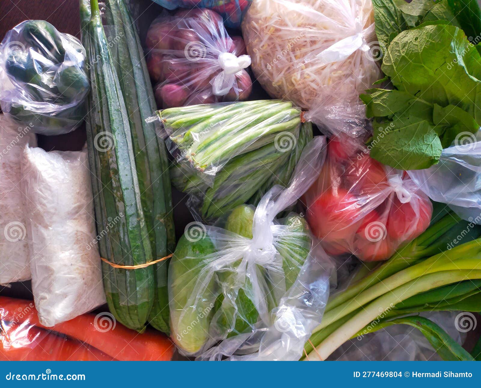 Vegetable Groceries in Plastic Bags on the Table Stock Photo - Image of ...