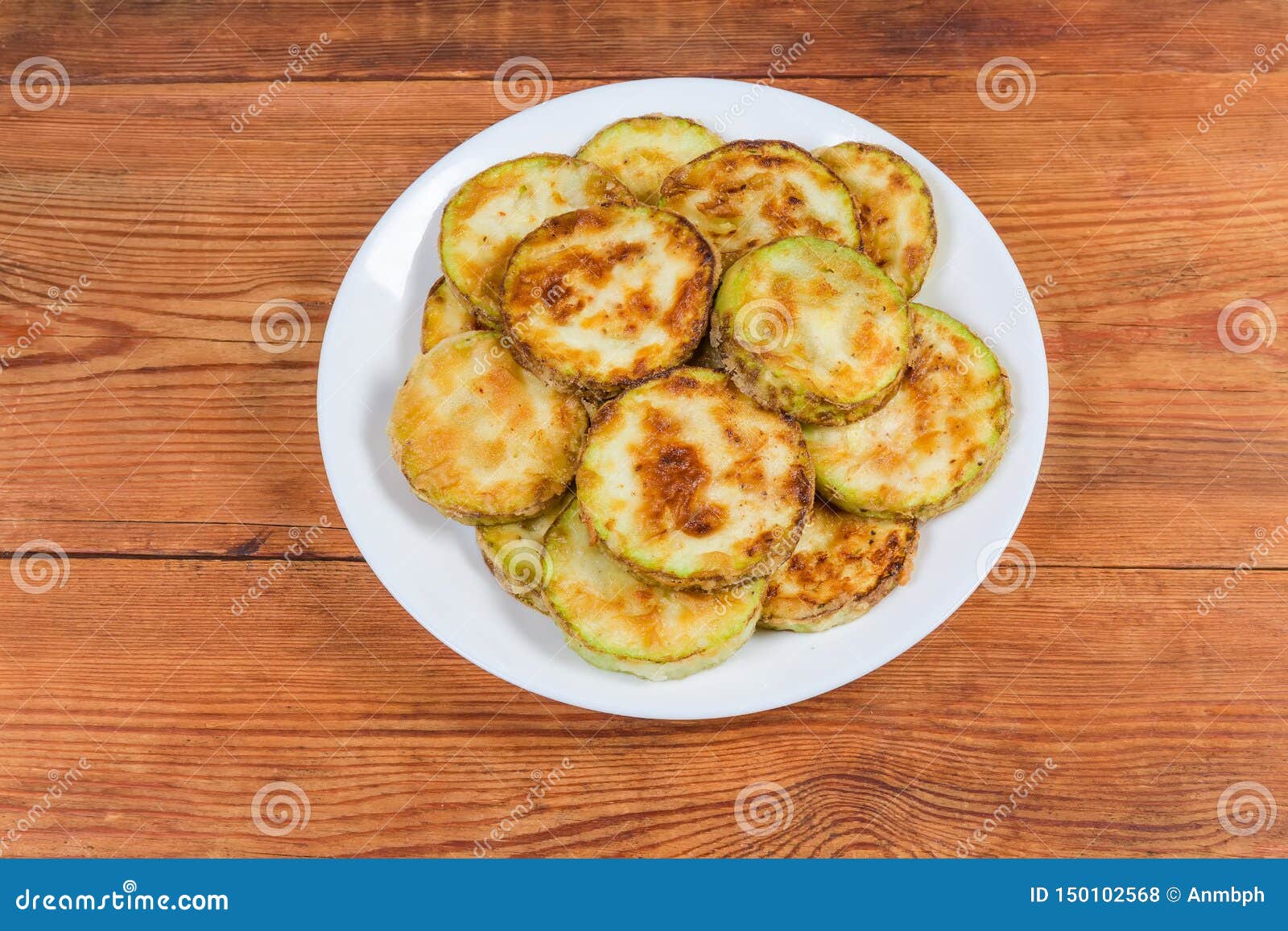 Vegetable Marrows Fried in Batter on Dish on Rustic Table Stock Photo ...