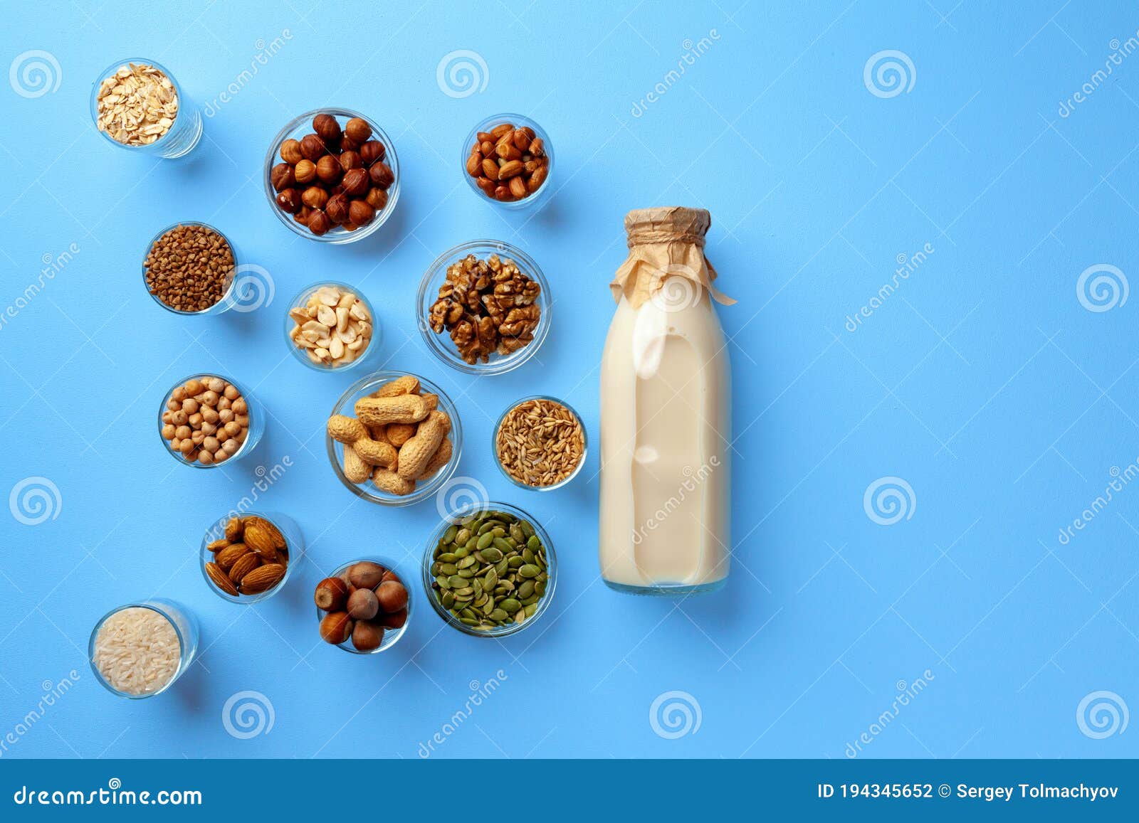 Vegetable Milk Concept with Milk Bottle and Bowls with Grains on Blue ...