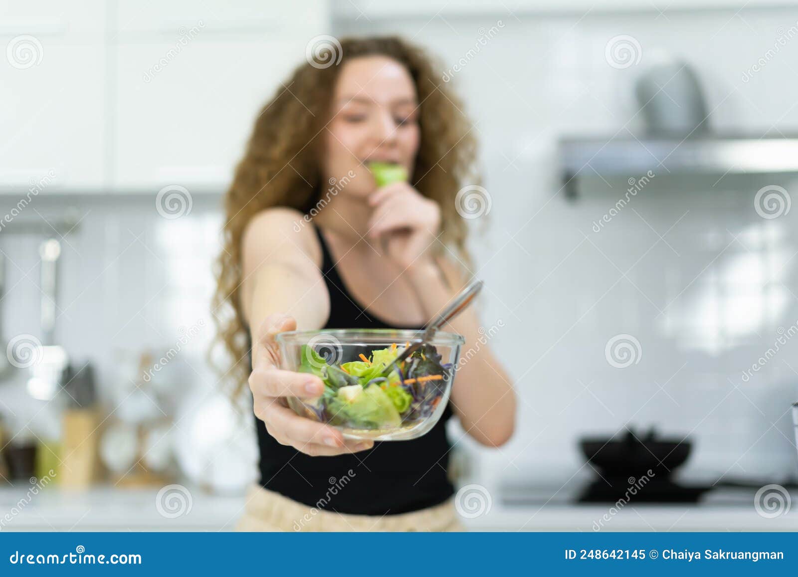 Vegetable Salad Cup In Hand Of Caucasian Woman While Eatting Vegetable