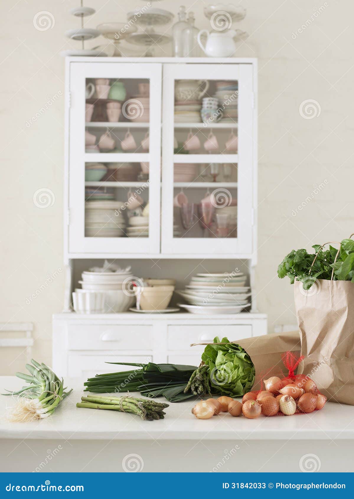 Vegetables on Counter with Utensils in Cupboard at Kitchen Stock Image ...