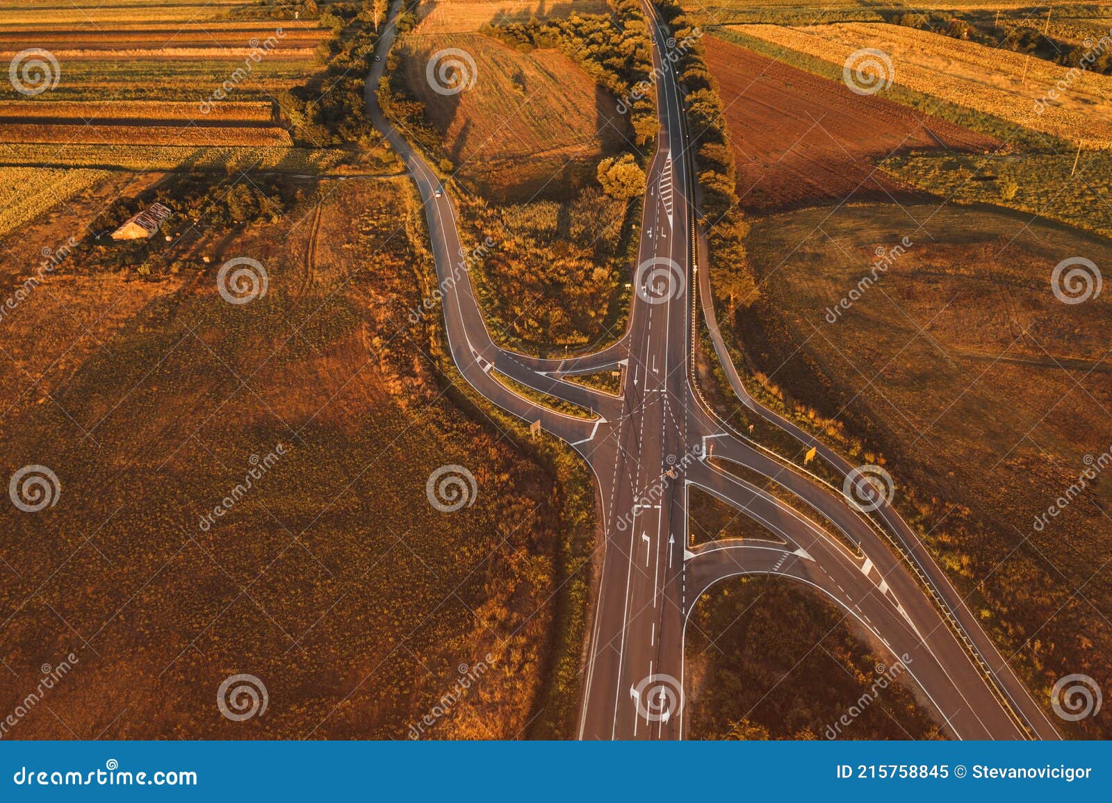 Vehicles on the Road Intersection through Countryside Landscape Stock ...