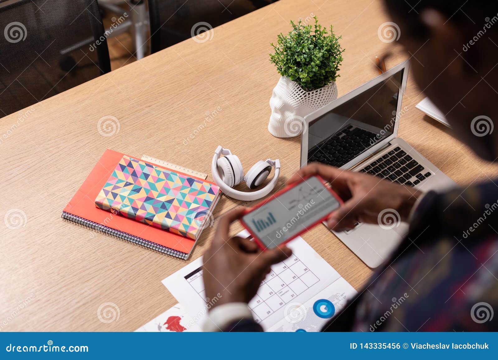 Man Checking the Information on Paper with His Smartphone Stock Photo ...