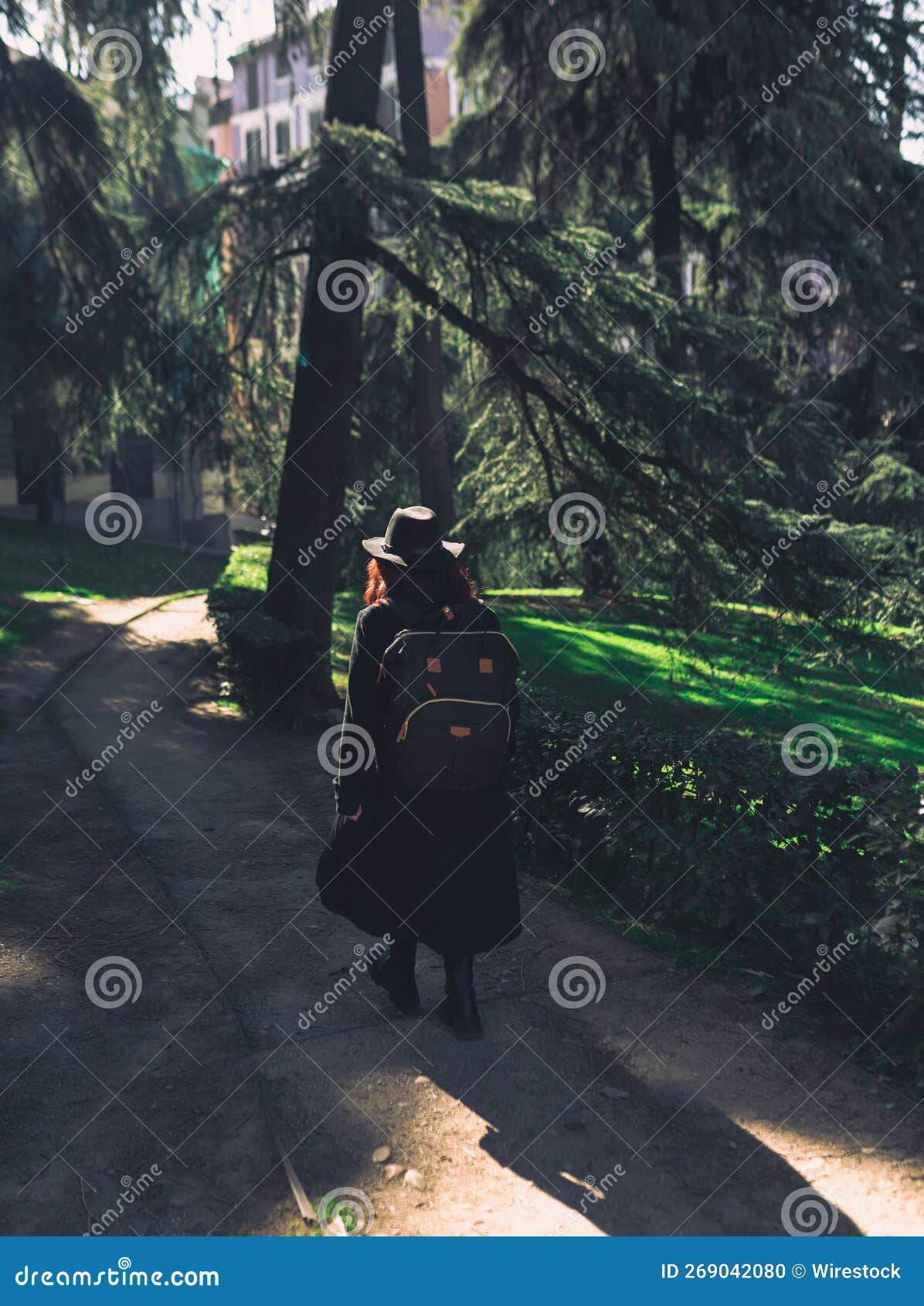 Vertical Back View of a Young Female Wearing Black Coat and Backpack in ...