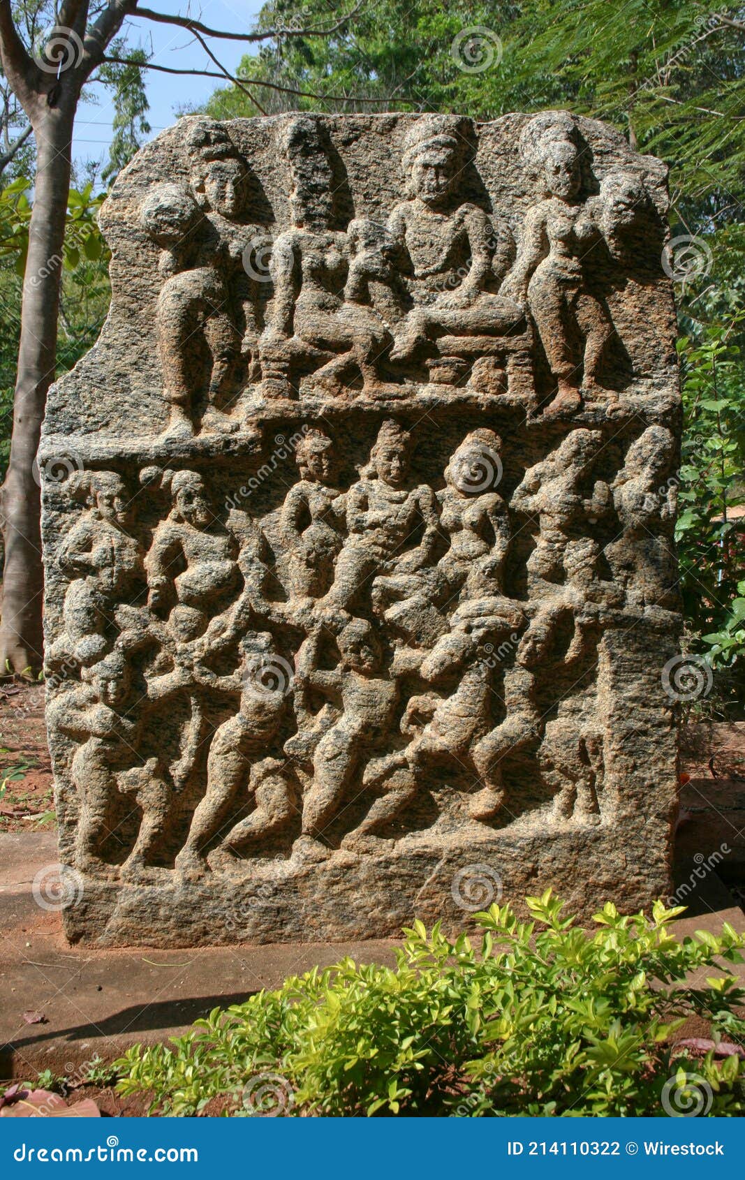 Vertical of a Bas-relief Sculpture on the Stone Surrounded by Greens ...