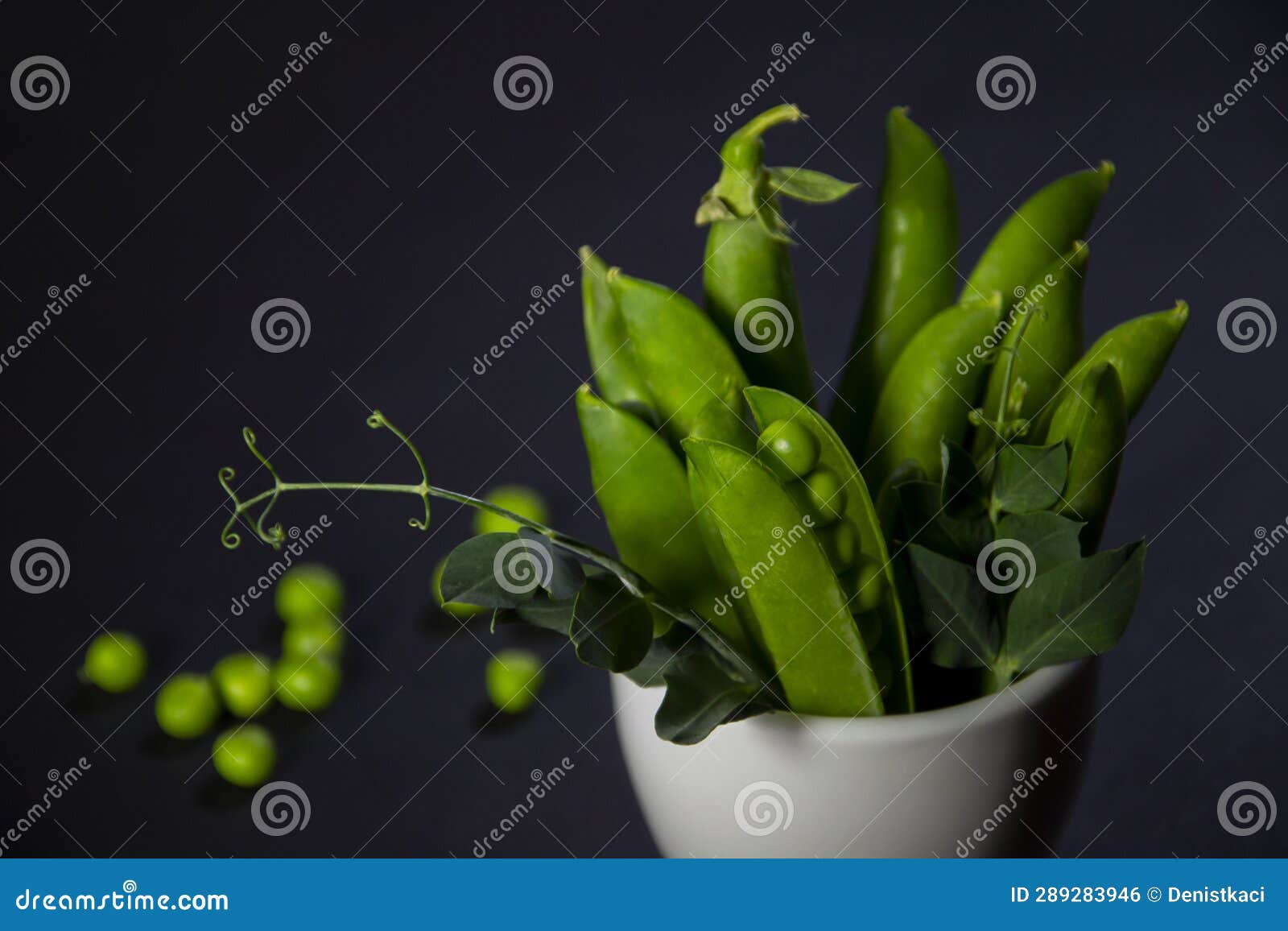 Vertical Bunch of Green Peas in a Cup on a Black Background Stock Photo ...