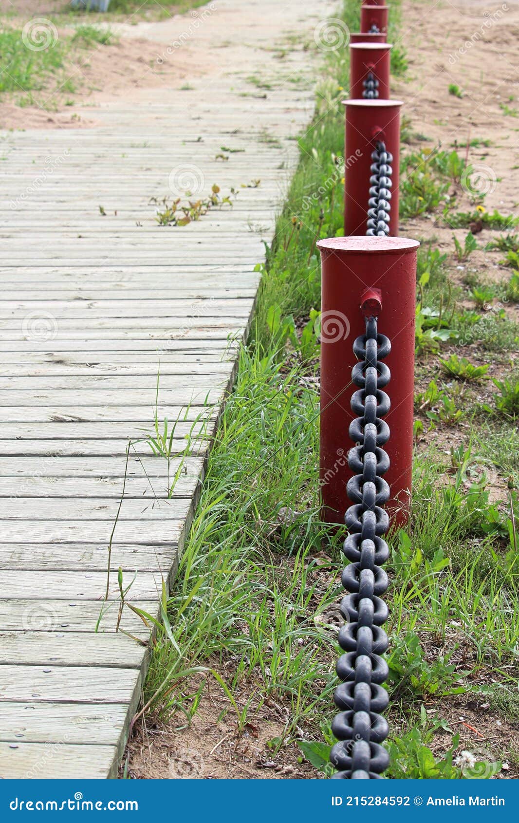 Vertical of a Chain Link Fence beside a Boardwalk Stock Photo - Image ...