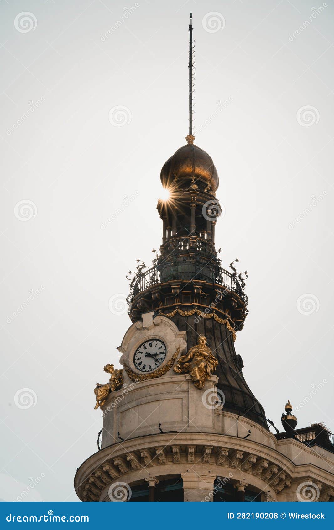 Vertical of a Clock Tower with Golden Sculptures in the Sunlight Stock ...