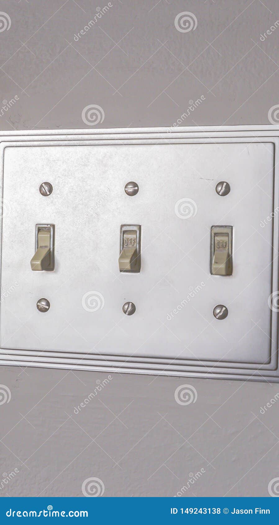 Vertical Close Up of the Electrical Light Switch Against the White Wall ...