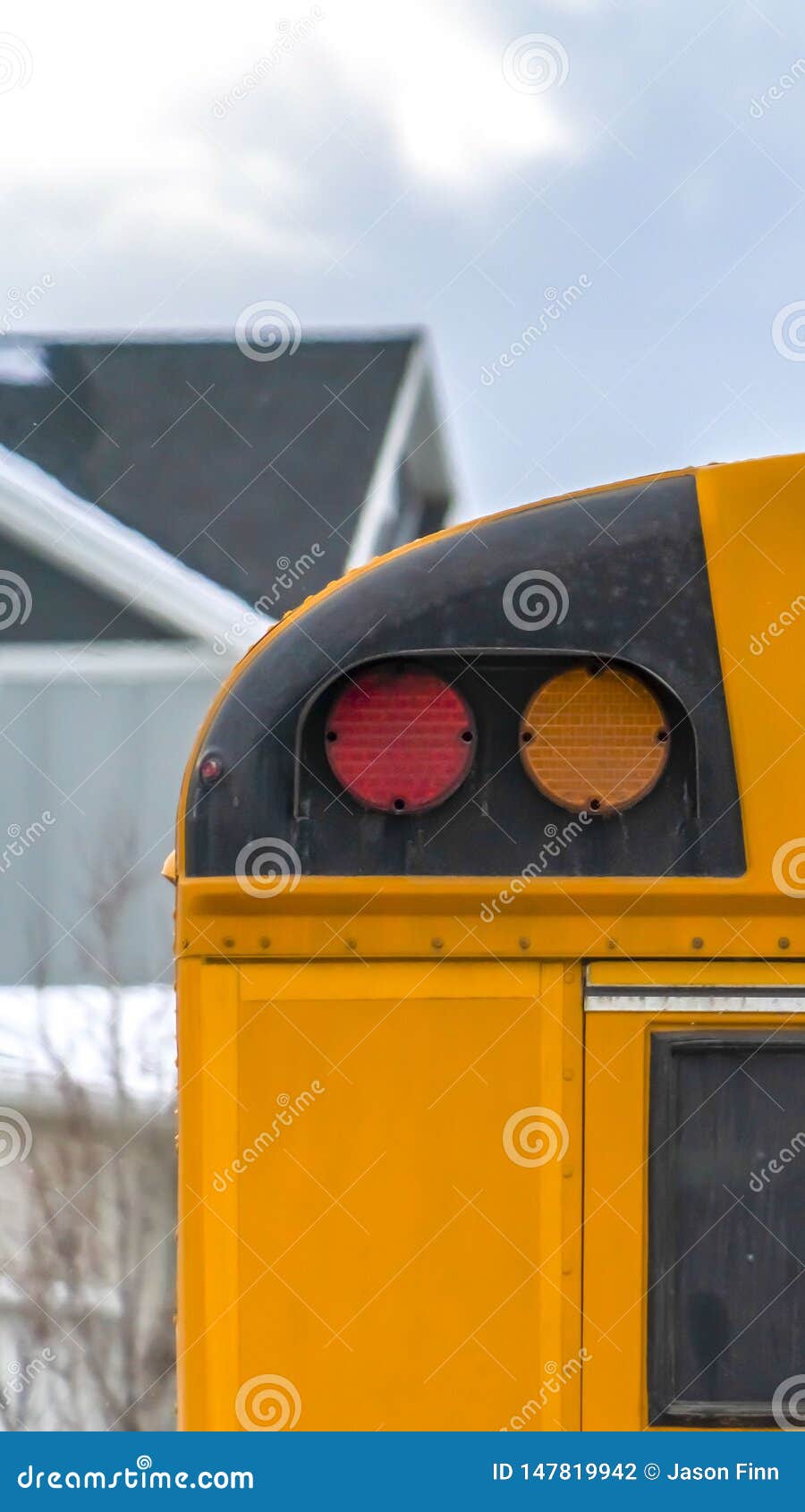 Vertical Close Up of the Rear of a School Bus with a Window and Several ...