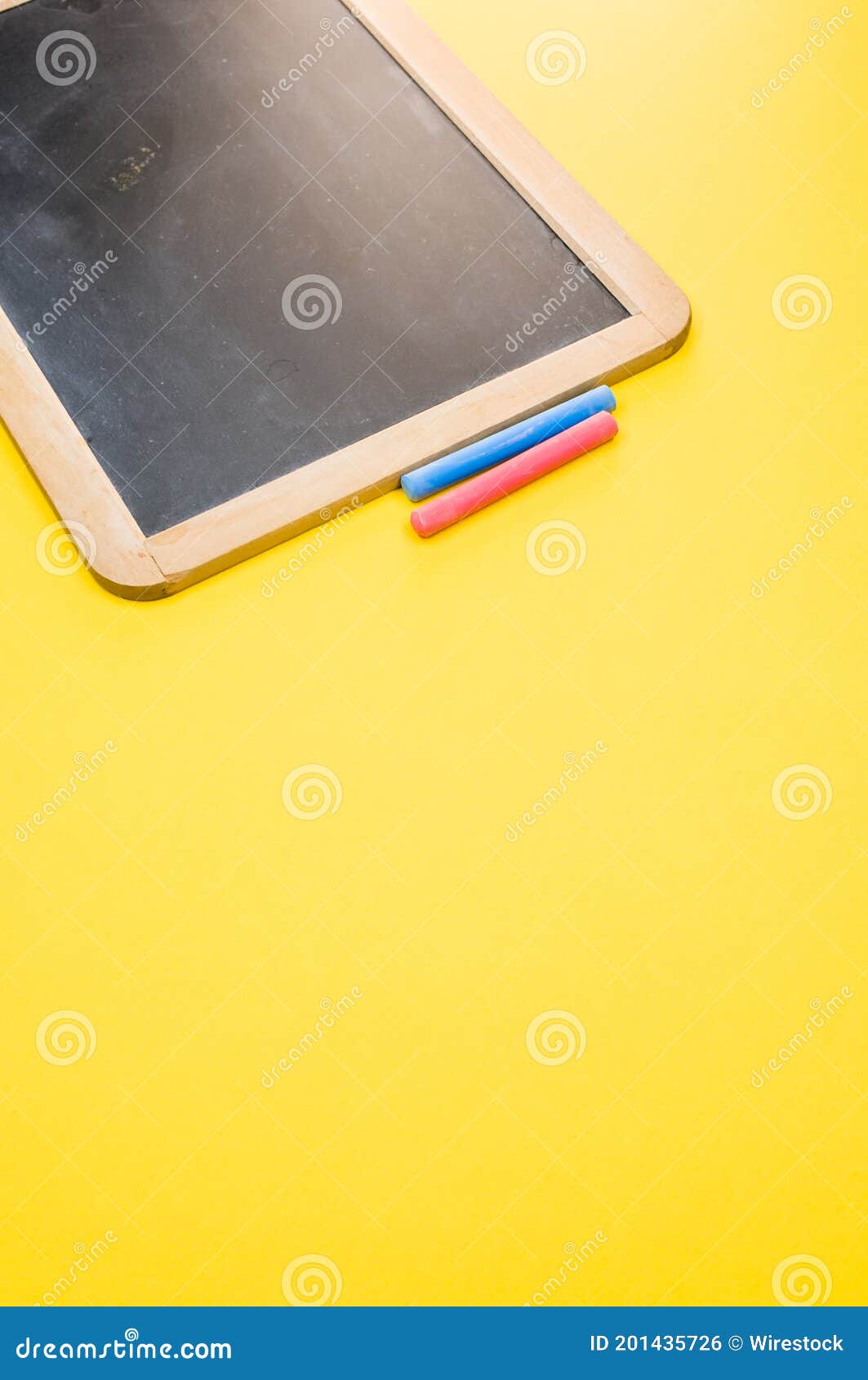 Vertical Closeup of a Blackboard with Chalks on a Yellow Surface Stock ...