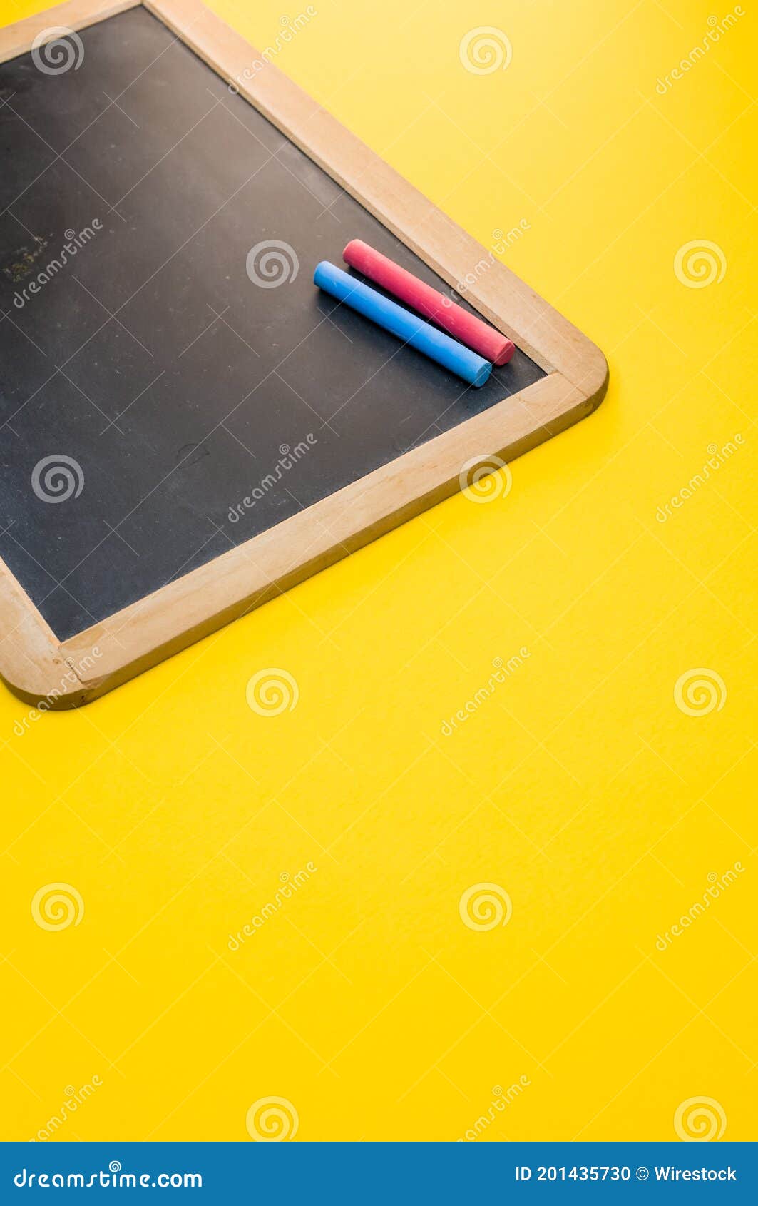 Vertical Closeup of a Blackboard with Chalks on a Yellow Surface Stock ...