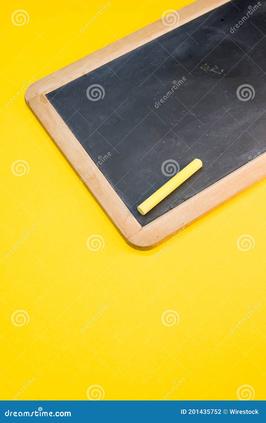 Vertical Closeup of a Blackboard with Chalks on a Yellow Surface Stock ...