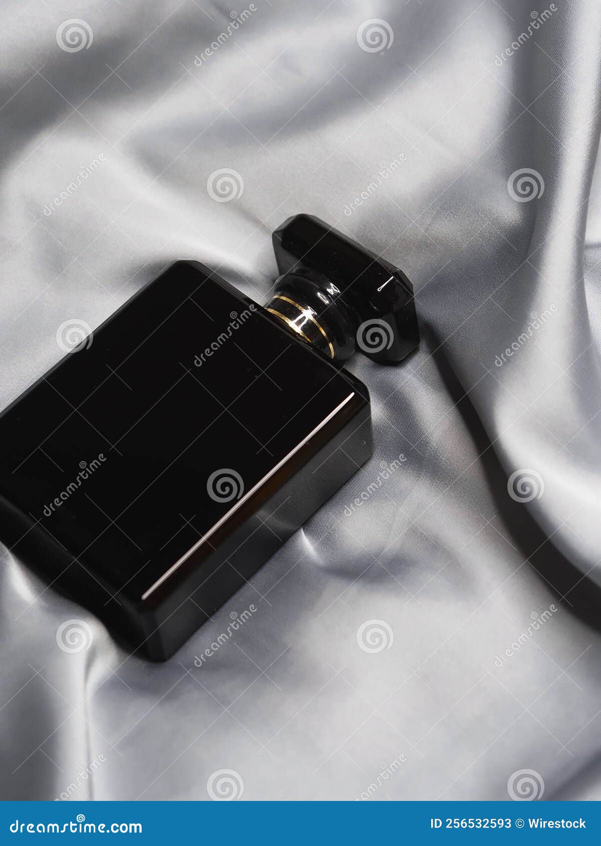 Vertical Closeup High-angle Shot of a Black Perfume Bottle on a Grey ...