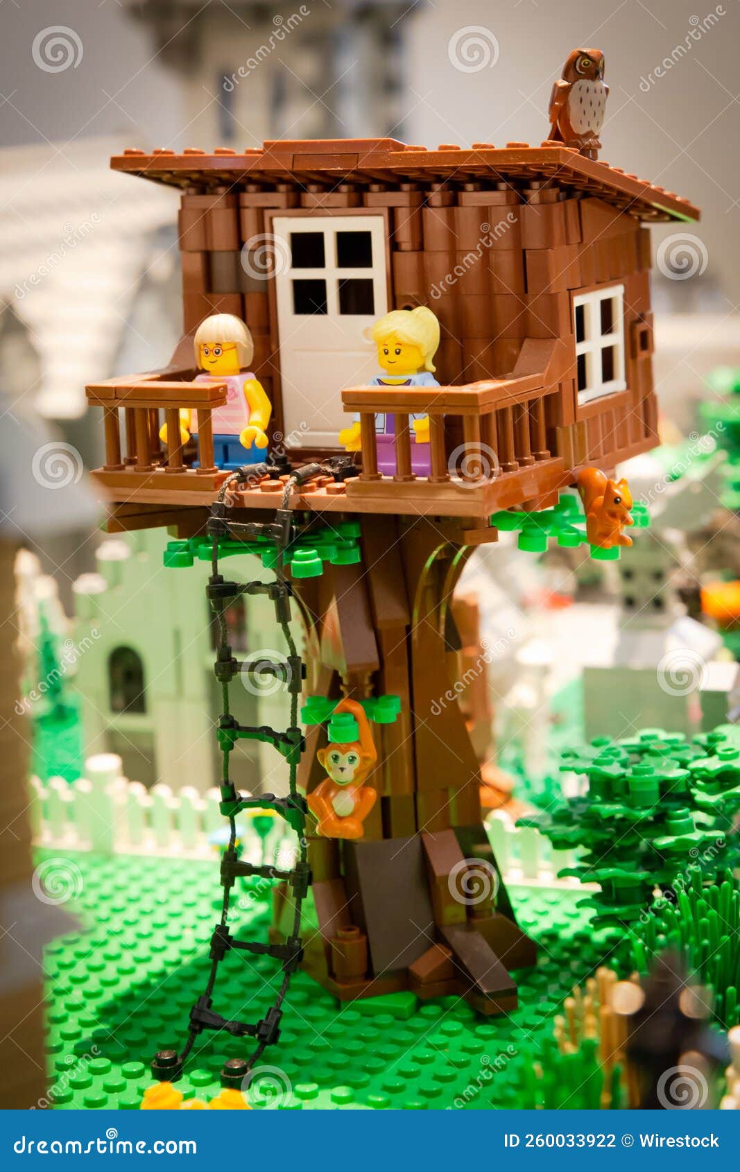 Vertical Closeup of a Lego House on a Tree with People Editorial ...