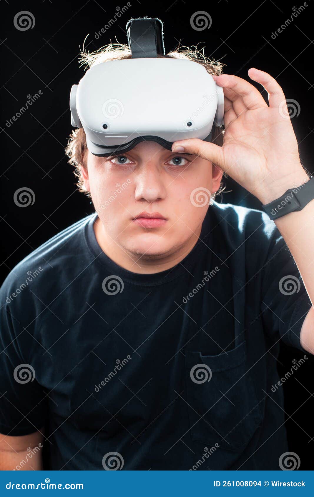 Vertical Closeup of a Nerdy Young Man with a VR Headset Against a Black ...