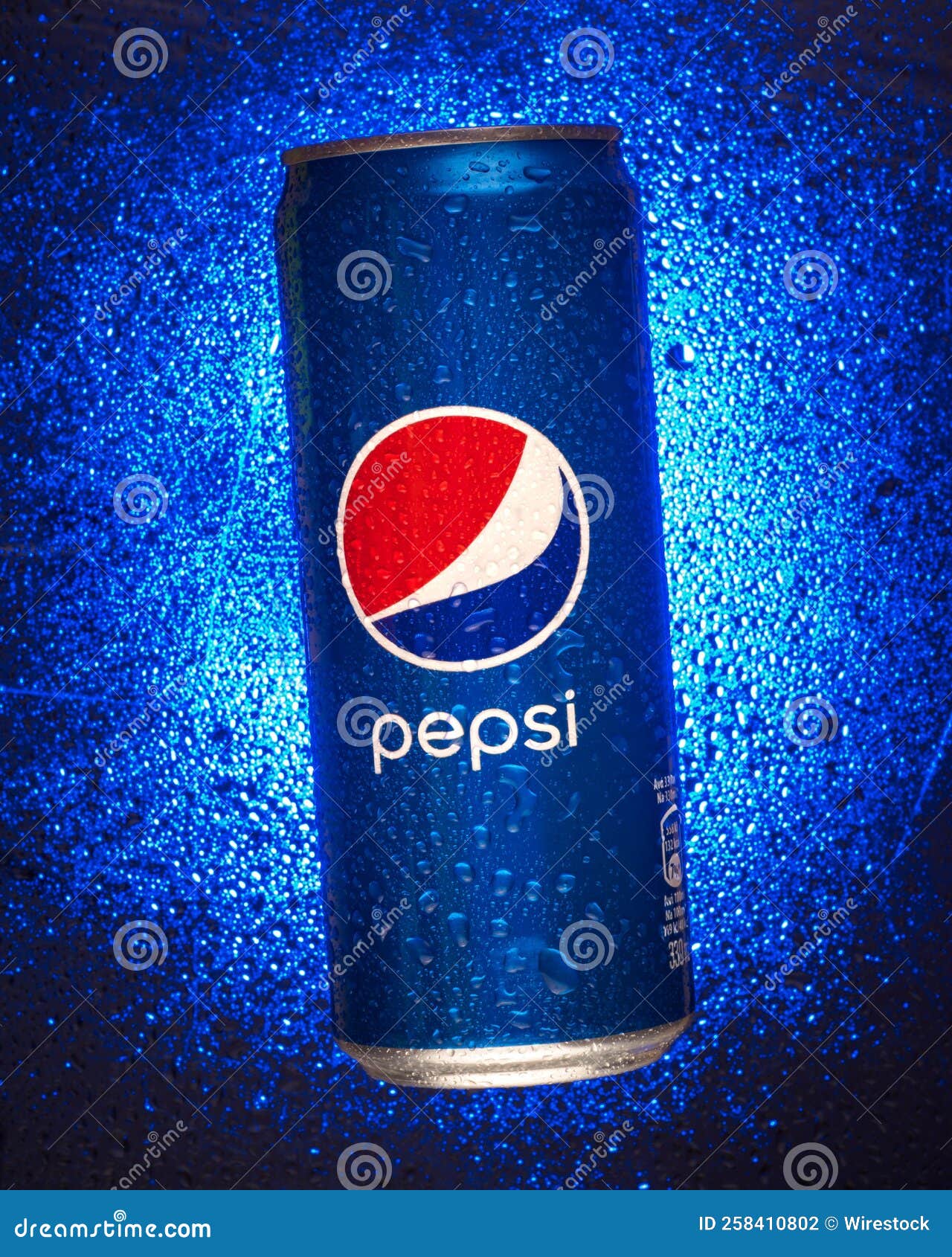 Vertical Closeup of a Pepsi Can on a Blue Background with Water Drops ...